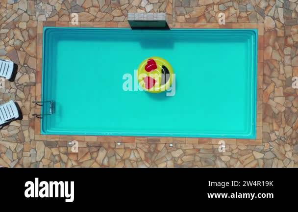 Mococa, Sao Paulo, Brazil. Smile emoji pool float scene at swimming ...