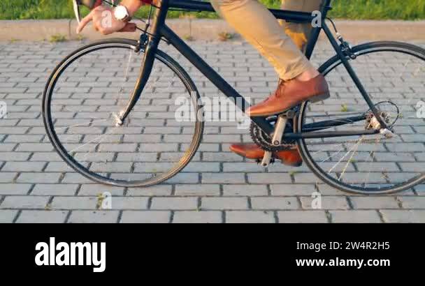 Close up of wheels of bicycle spinning while caucasian casual man ...