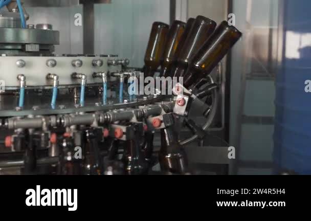 Process of bottling beverages on drinks production soft drinks, lemonade, beer in glass bottles ...