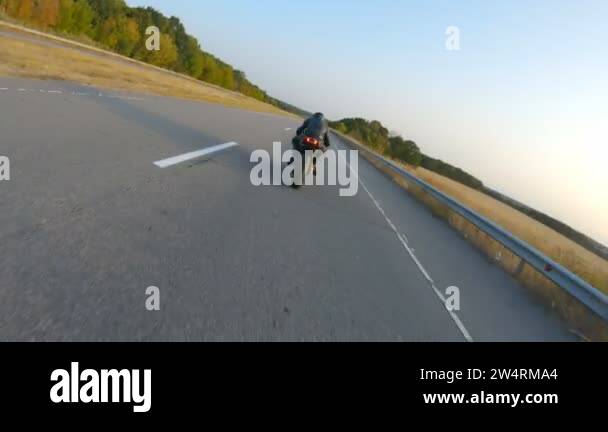 Camera moving around of biker riding on modern sport motorbike at ...
