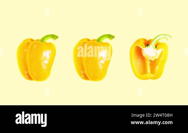 Stop motion animation. Three yellow juicy bell peppers being cut in ...