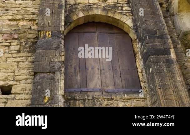 Arched window with wooden shutters. Ancient antique church with ...