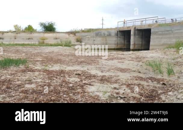 Ecological disaster. cracked soil ground and empty bridge over dried ...