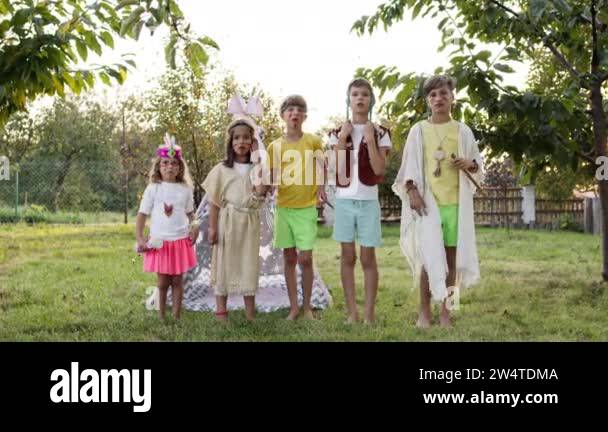 Five Children In The Garden In Costumes Of Indians. Children Stand From ...