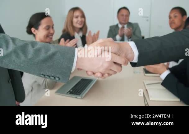 Two unrecognizable businessmen standing in front of each other doing ...
