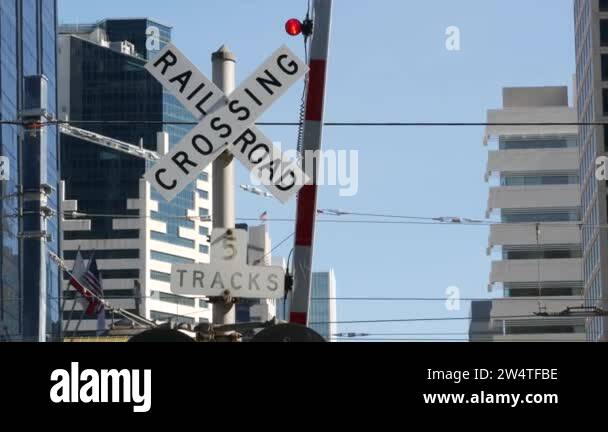 Level crossing warning signal in USA. Crossbuck notice and red traffic ...