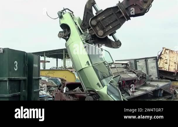 Giant Claw of Junkyard Crane Grabbing and Lifting an Old Car Stock ...