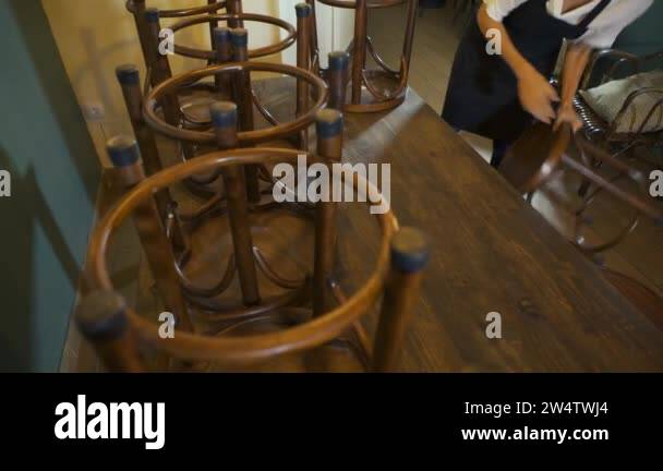 Close up shot of chairs being put on the table at a restaurant dining ...