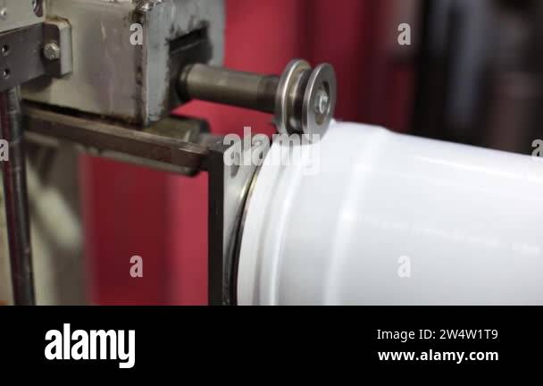 Manufacturing of ventilation and drainage pipes. A man works with a ...