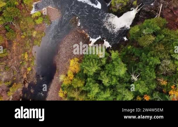 Incredible beautiful look down aerial flying over Saxon Falls and the ...