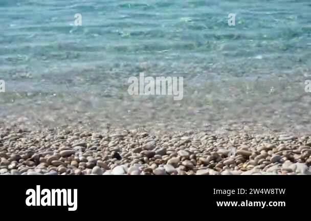 Sea water splashes on the beach. Pure sea (oceanic) water from the sea ...