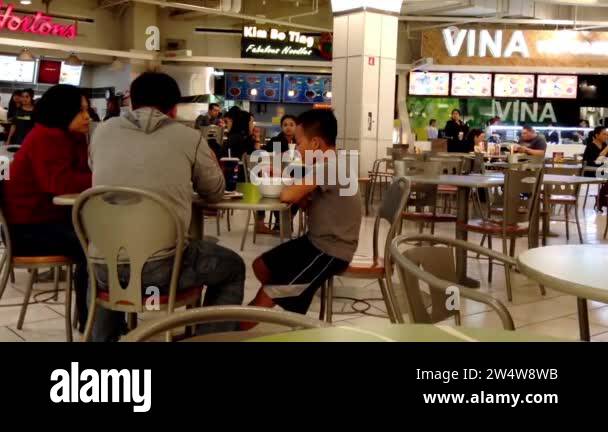 People enjoying mid day break in modern mall food court cafeteria Stock ...