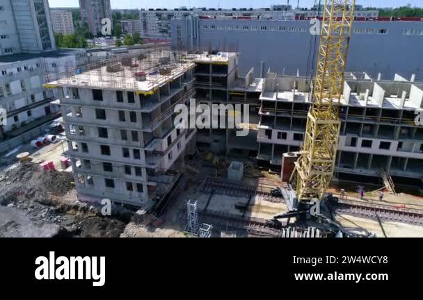 Movement from unfinished building. Workers are building a monolithic ...