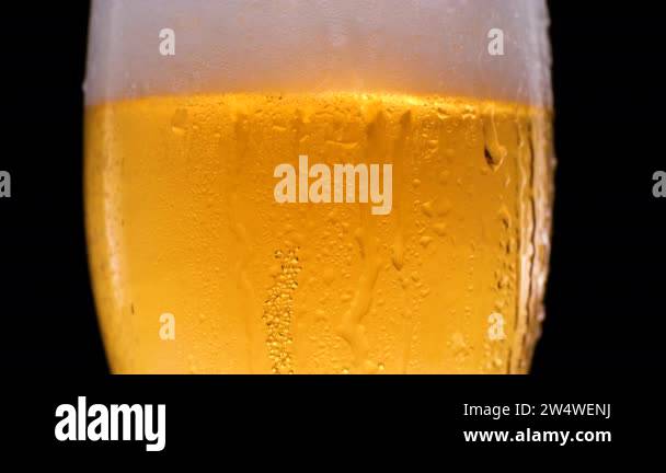 Beer glass with falling water drops. Refreshing and cold beer in a beer ...