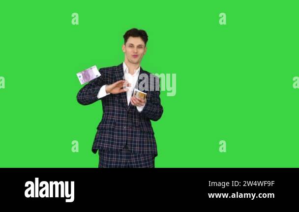 Man in formal suit throwing money in the air on a Green Screen, Chroma ...