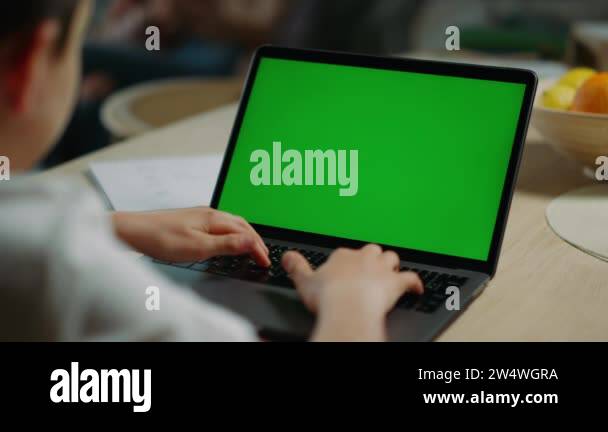 Boy surfing internet green screen laptop. Student typing keyboard ...