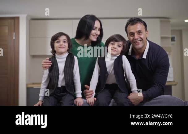 Positive interracial family posing in living room at home. Portrait of ...