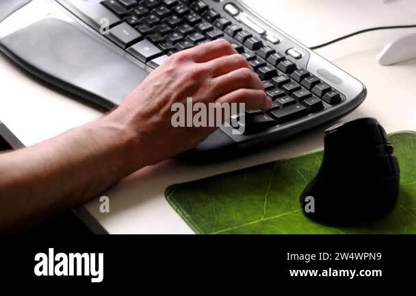 Business man or professional programmer typing on ergonomic keyboard ...