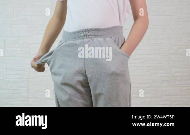 Poor teen, teenager boy showing empty pockets without money, moneyless ...