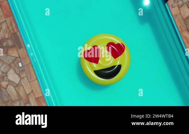 Mococa, Sao Paulo, Brazil. Smile emoji pool float scene at swimming ...