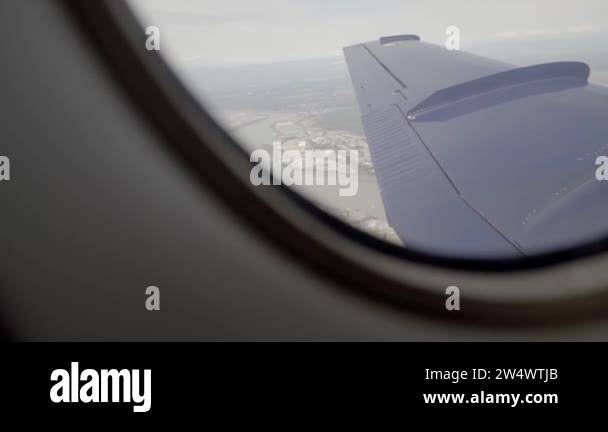 left wing of an airborne airplane as seen through the widow Stock Video ...