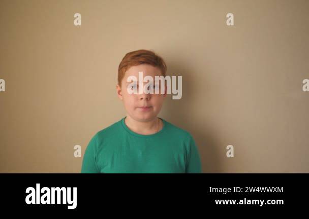 Close up emotions of male child with sorrowful expression on face ...