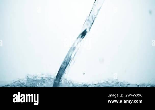 Brilliant stream of water in slow motion falls on smooth clean surface ...