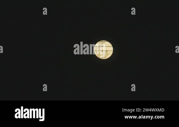 full oak moon moving pass power electric line on clear night sky Stock ...