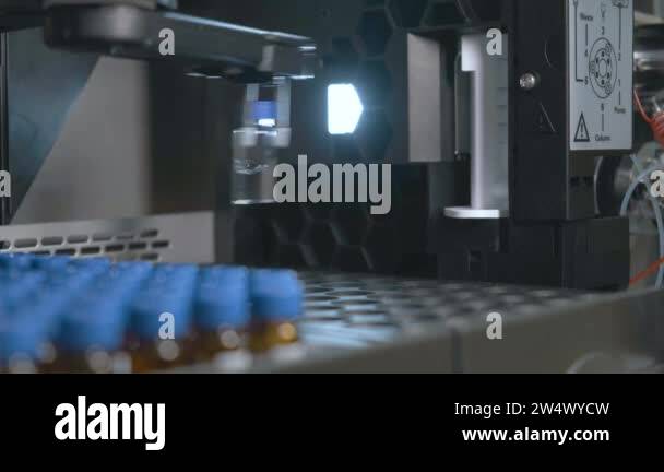 Auto sampler takes a vial and injects a sample into high performance liquid chromatography Stock ...