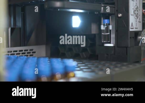 Auto sampler takes a vial and injects a sample into high performance ...