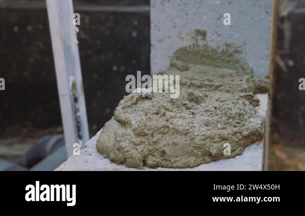 Construction work. Cinder block laying. Work of masons. Leveling the ...