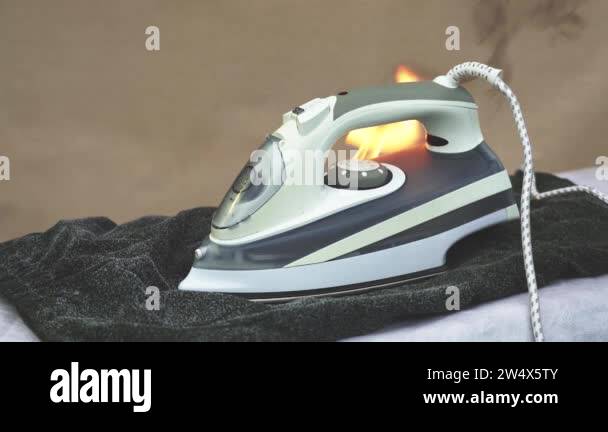Fire on the iron for ironing clothes. Household appliances on fire ...