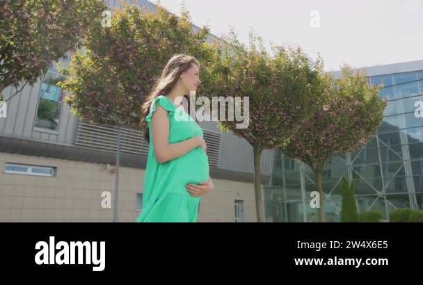 Beautiful Pregnant woman caressing her belly. pregnant women caressing ...