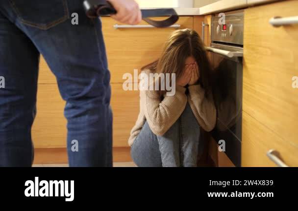 Angry father holding leather belt and threats crying daughter sitting ...