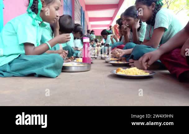 Unidentified poor classmates with uniforms sitting on the floor ...