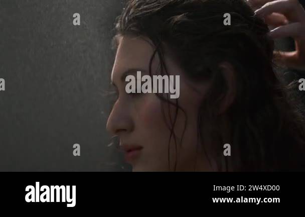 Stylist makes the hairstyle of a female model. Wet hair, spray water ...