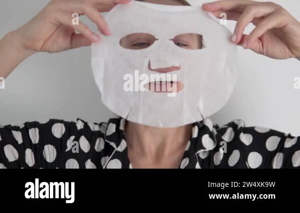 A woman makes a cloth mask to care for the face of the house Stock ...