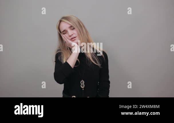 Holding hand on cheek, resting face in hands, offended displeased looks ...