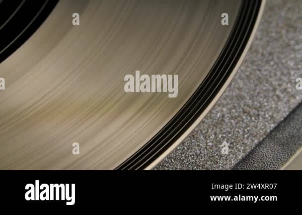 Extreme close up of a vinyl record spinning on a turntable. DJ ...