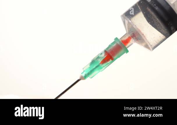 Syringe close up taking mixing blood of a patient with drug and ...