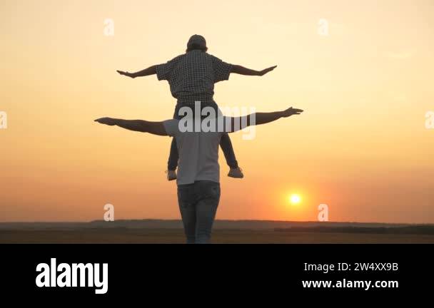 I dream of flying with my dad. son sits on fathers neck, play pilot ...