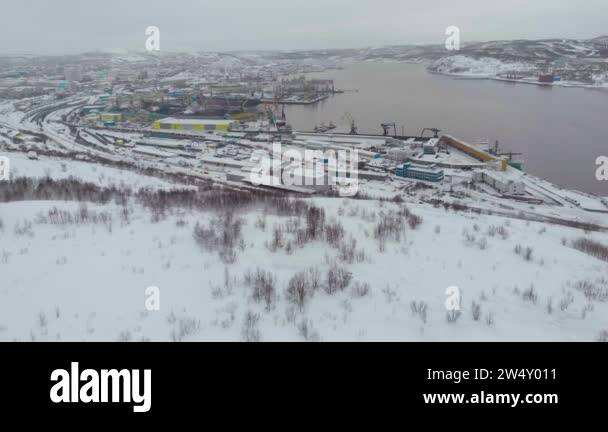Aerial view of seaport, Murmansk, Russia. Long production halls on the ...