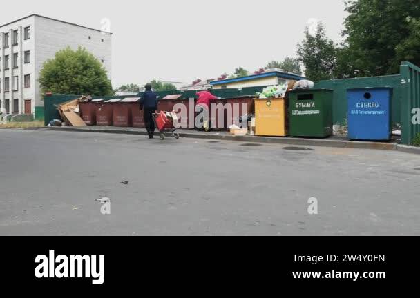 Beggars, tramps, and poor men collecting and sorting garbage in public ...