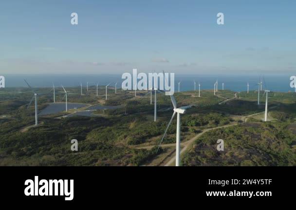 Wind power generators. Wind turbines near the sea. Solar Farm with ...