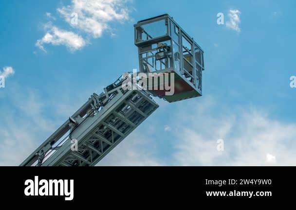 A lift on a fire engine is moving up and will rescue an injured person ...