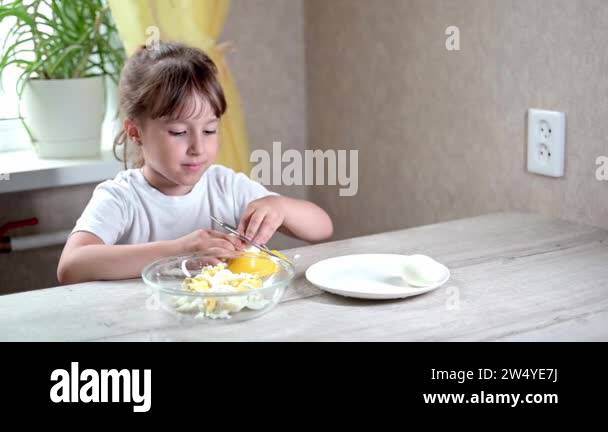 lifestyle preschooler child girl cook food in the kitchen. development ...