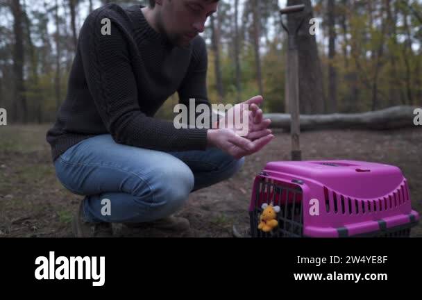 Upset male owner of dead pet says goodbye to animal before funeral in ...