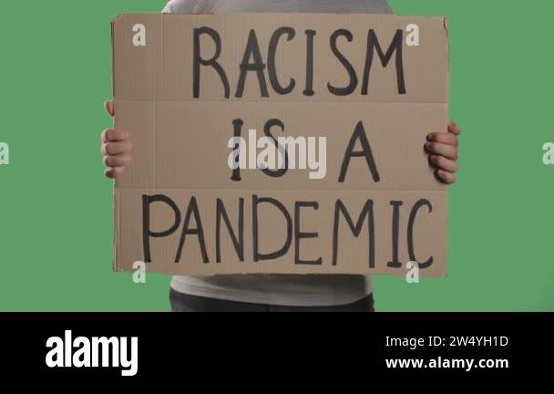 A man holds in front of him a poster from a cardboard box with the ...