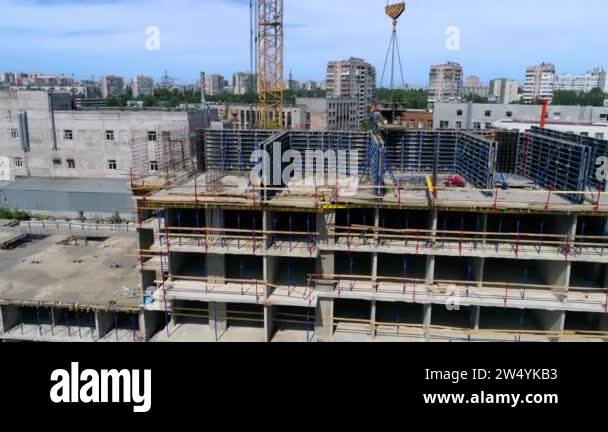 Construction site with an unfinished building. Lifting a concrete ...