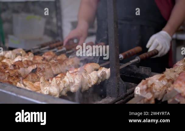 Cooking Juicy Pork Kebab on Open Grill in a Food Court on a Metal ...